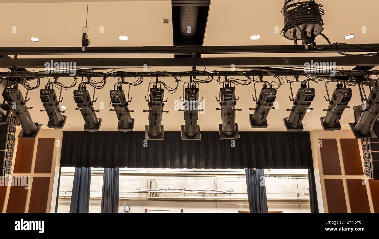 Close up photo of new large theater stage spotlights, lamps, hung along ...
