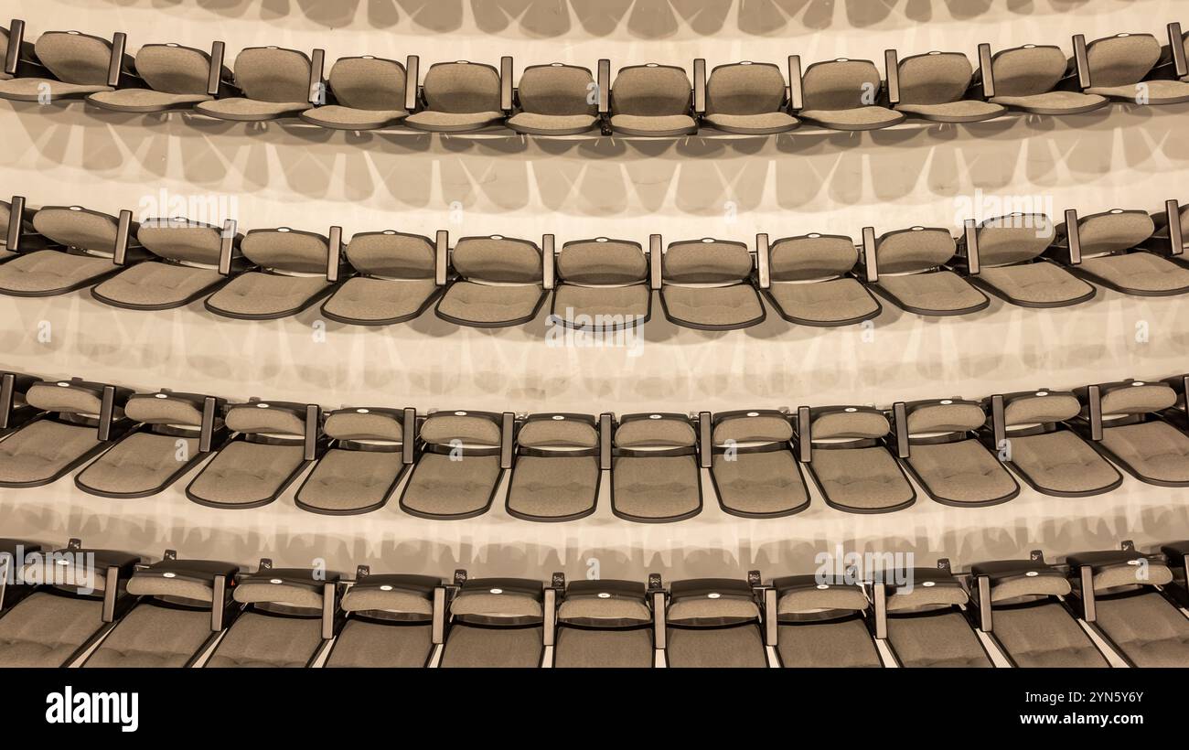 Overhead image of empty tan / gray theater, auditorium seats, chairs ...