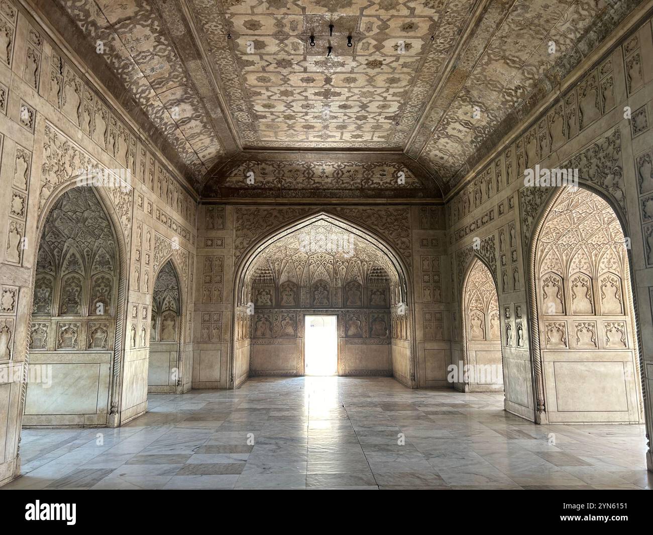 Interior empty rooms with intricate stone and marble work, and light ...