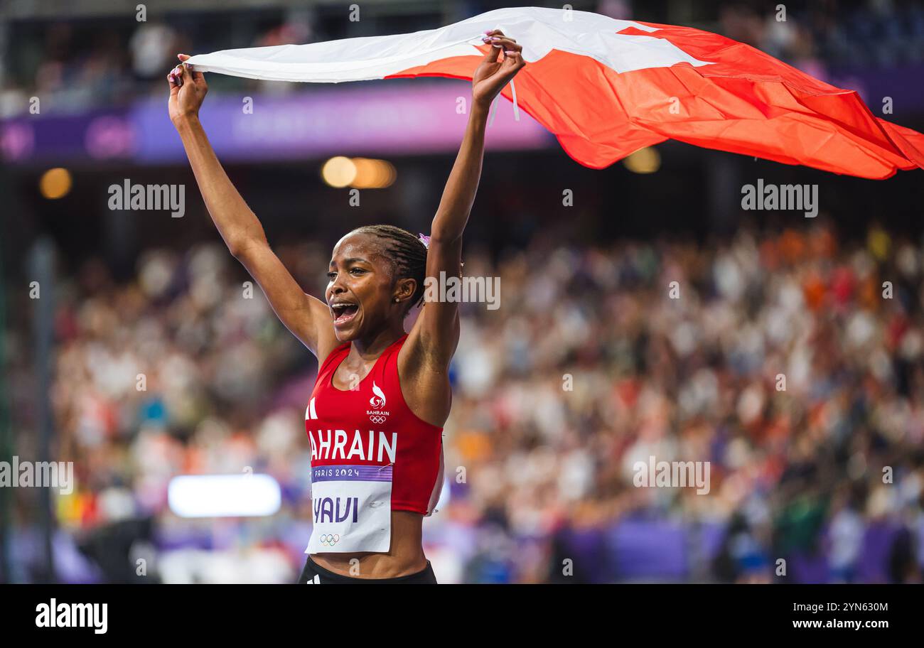 Winfred Yavi celebrating her medal with her country's flag at the Paris ...