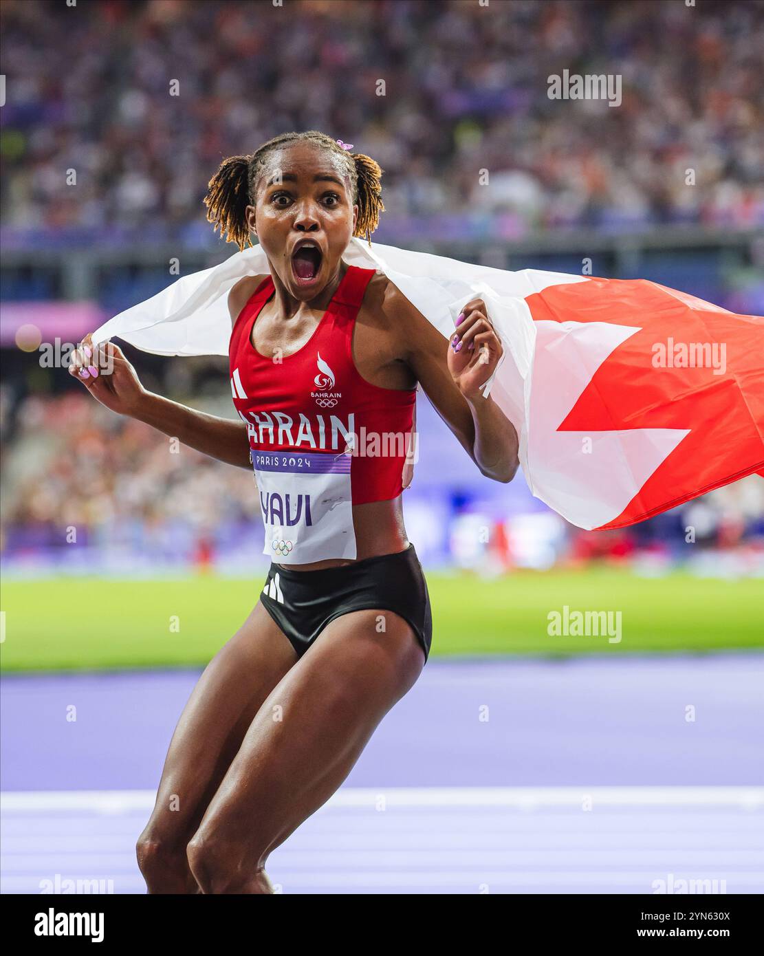 Winfred Yavi celebrating her medal with her country's flag at the Paris ...