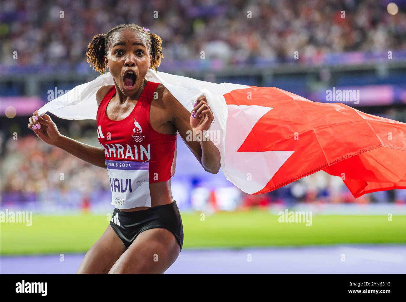 Winfred Yavi celebrating her medal with her country's flag at the Paris ...