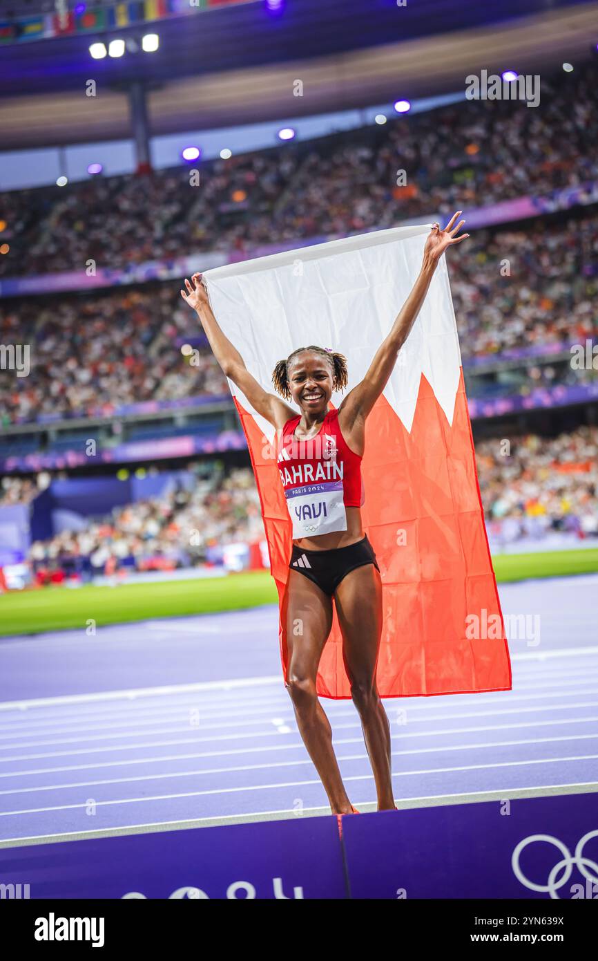 Winfred Yavi celebrating her medal with her country's flag at the Paris ...
