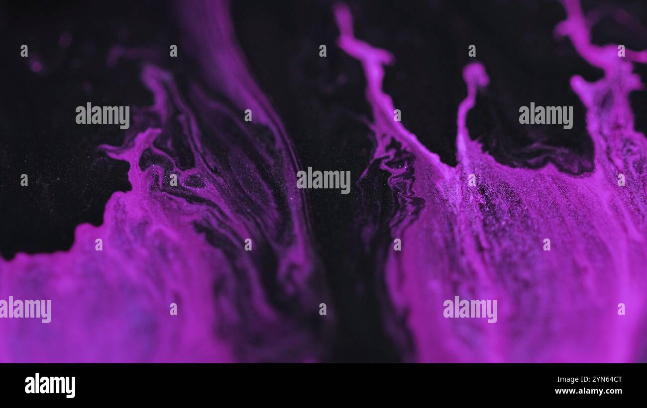 Bokeh light. Glowing liquid flows. Defocused neon purple pink black ...
