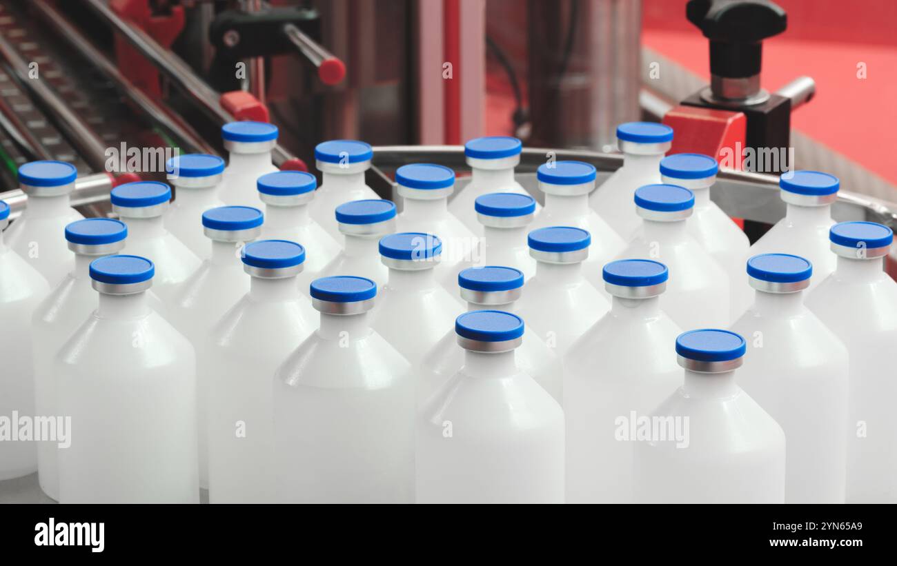 White plastic bottles with blue caps for medicines and vaccines in a ...