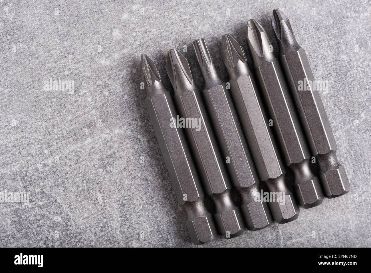 Set of bits for tightening screws. On gray concrete background. View ...