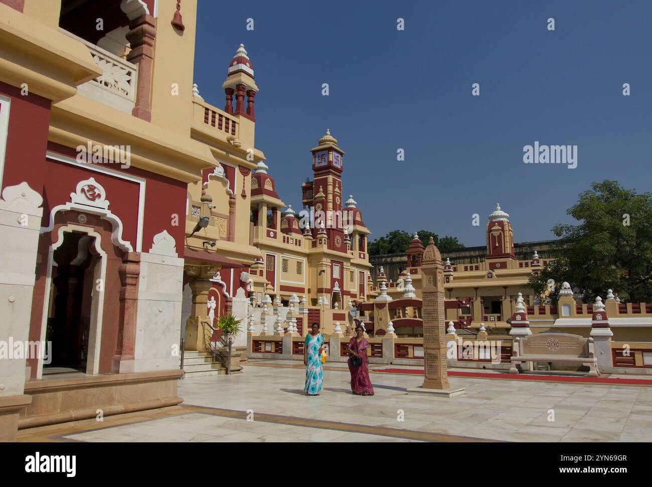 Two Indian Hindu women in traditional dress outside colourful ...