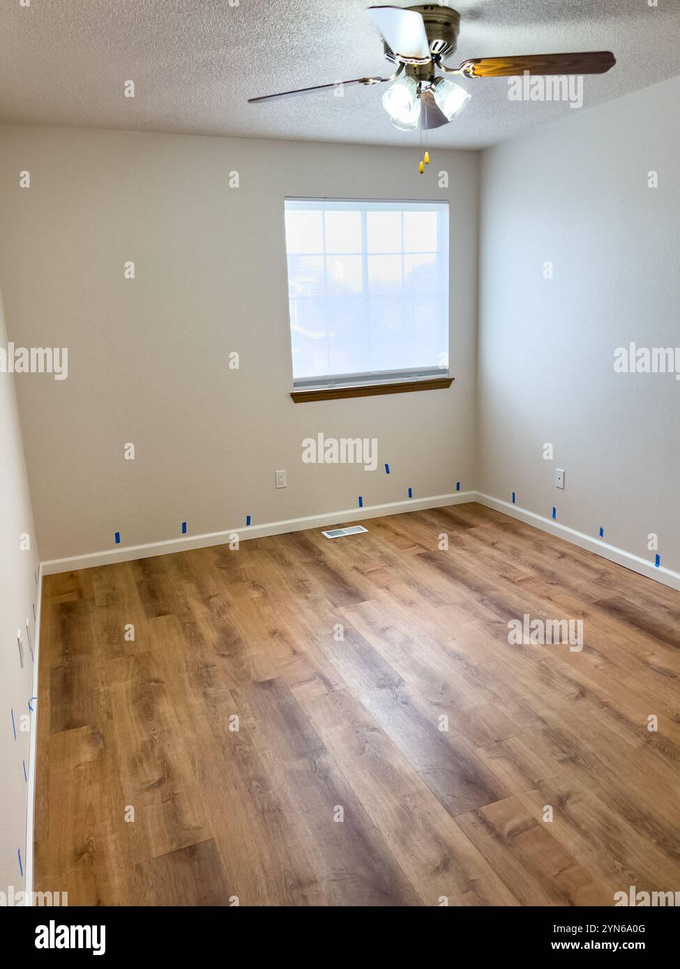 Vinyl Plank Flooring Installation with Baseboards Stock Photo - Alamy