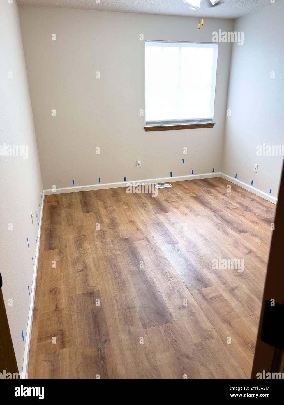 Vinyl Plank Flooring Installation with Baseboards Stock Photo - Alamy