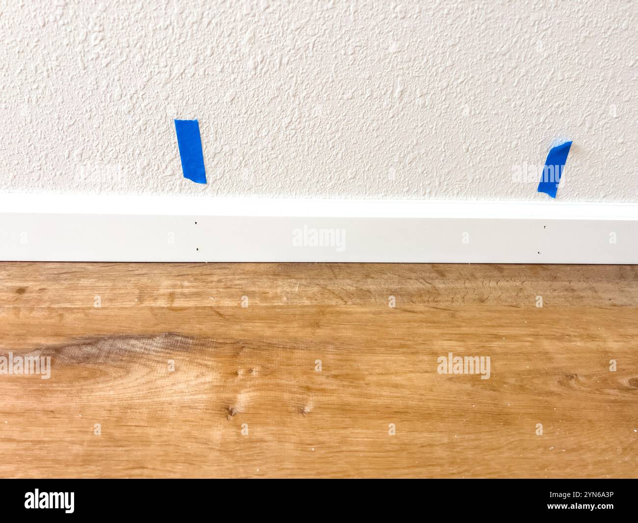 Vinyl Plank Flooring Installation with Baseboards Stock Photo - Alamy