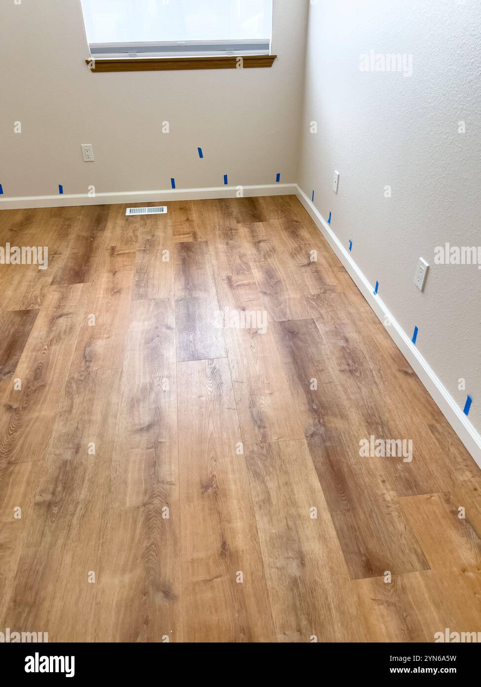 Vinyl Plank Flooring Installation with Baseboards Stock Photo - Alamy