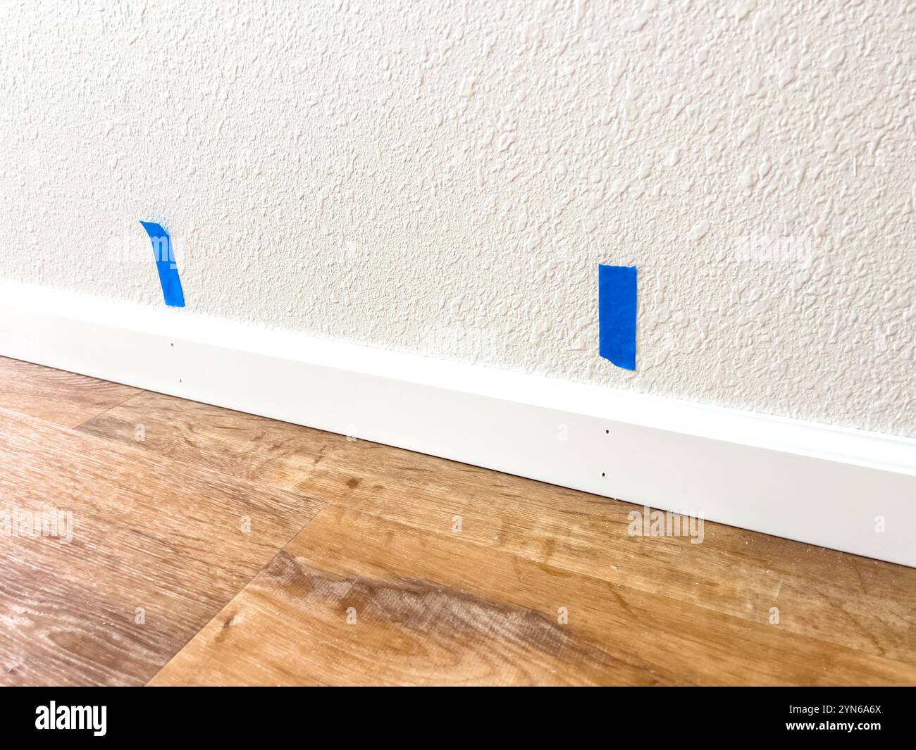 Vinyl Plank Flooring Installation with Baseboards Stock Photo - Alamy