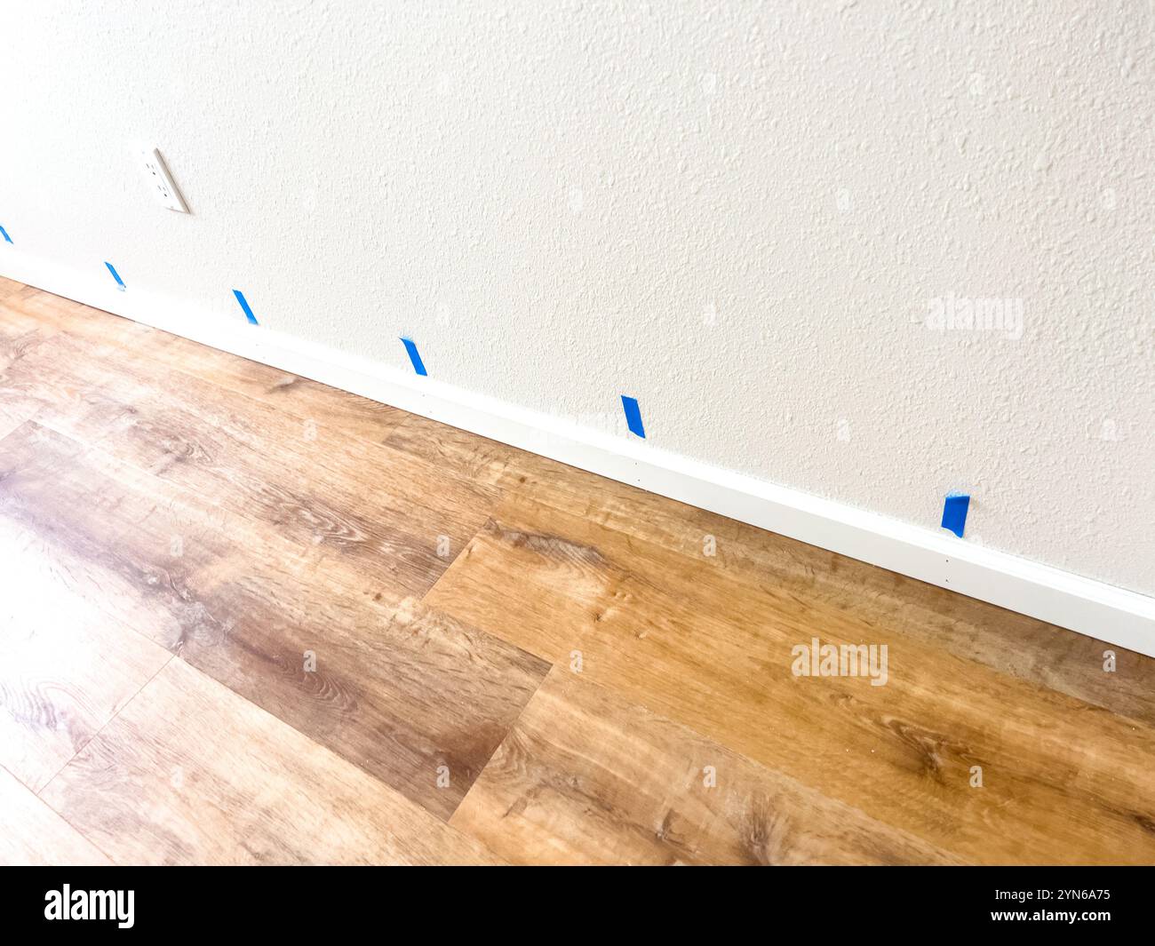 Vinyl Plank Flooring Installation with Baseboards Stock Photo - Alamy