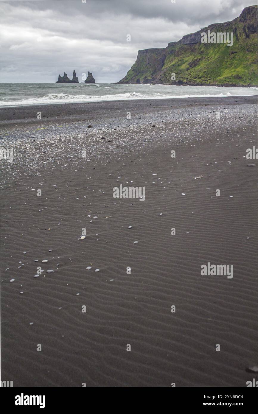 Black beach in Vik i Myrdal and three cliffs in the background, Iceland ...