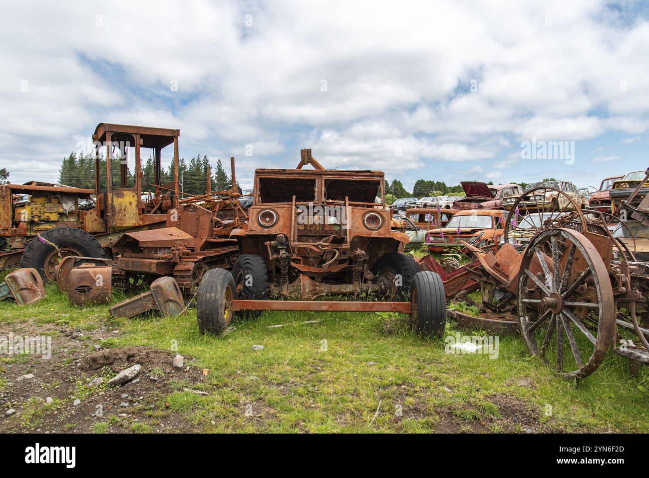 Antique cars on a big scrapyard at the end of Old Coach Road Trail ...