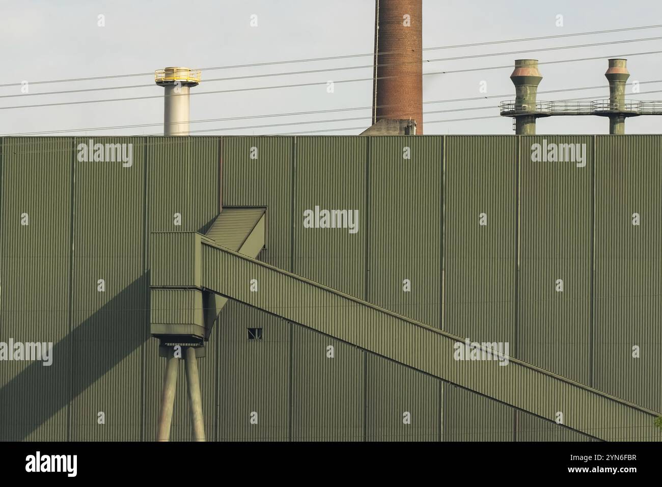 Detailed view of an industrial building with high voltage power lines ...