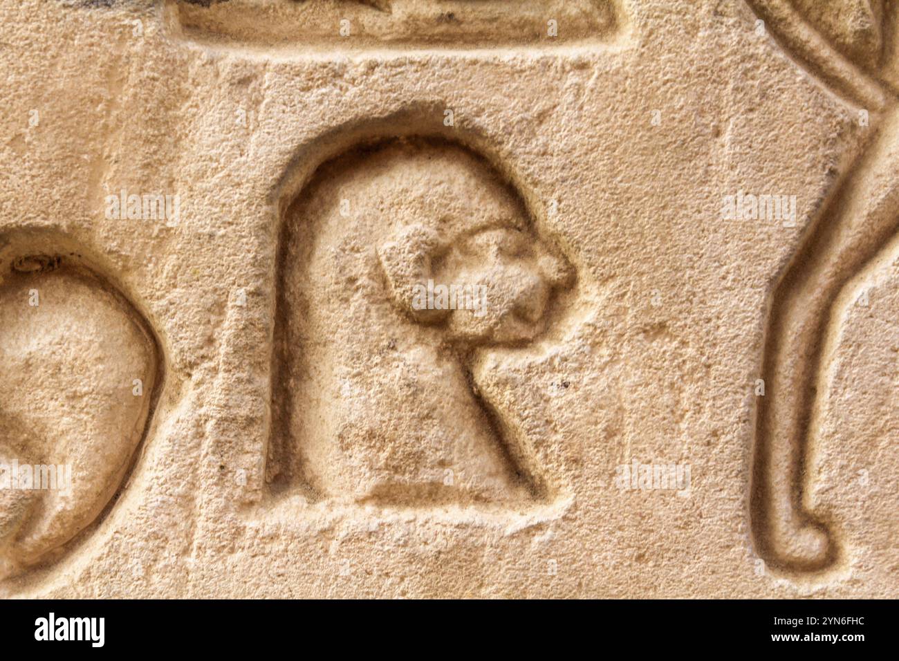 Carvings of a funny looking face at the wall of a temple in Egypt Stock ...
