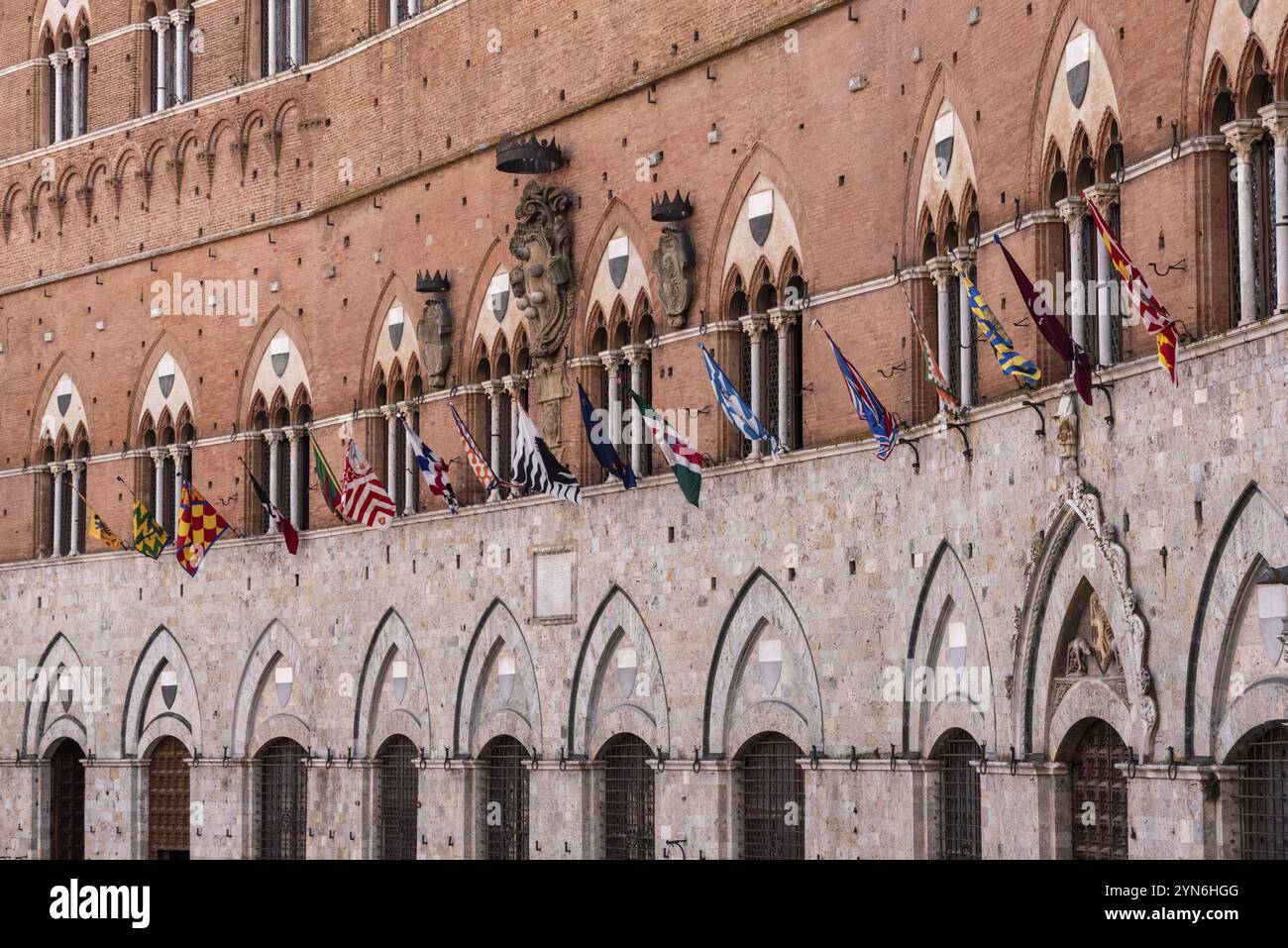 Contrade flags of all city districts hanging at the facade of the ...