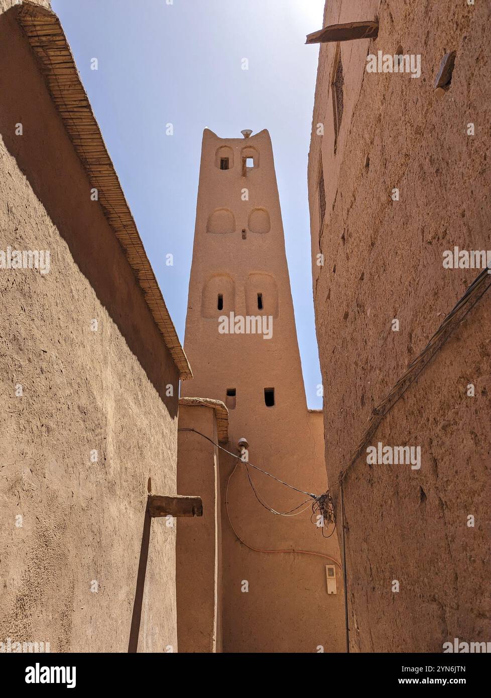 Minaret of a historic mosque built of clay in the ancient city center ...