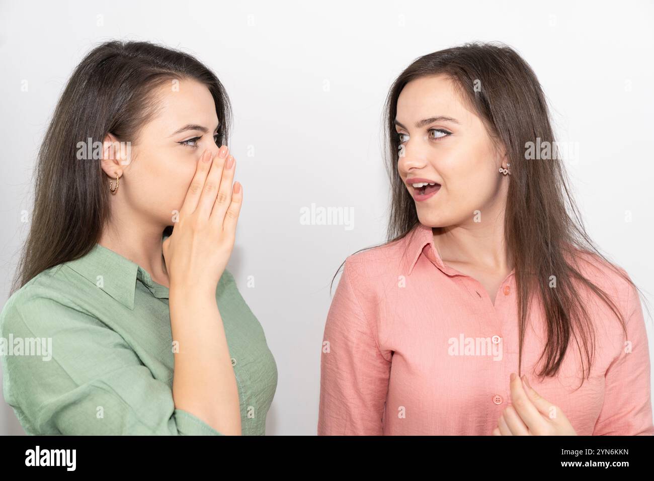 Two young women gossip Stock Photo - Alamy