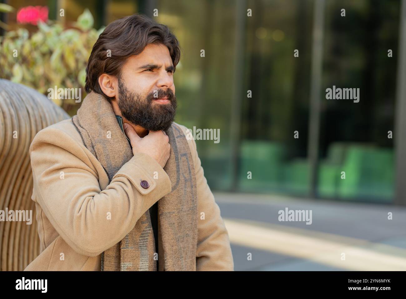 Ill sick Indian young businessman tourist suffering from a sore throat ...