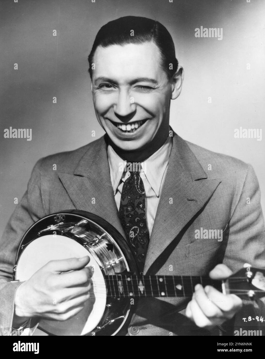 A Portrait of British Film Comedian GEORGE FORMBY playing his ukelele ...