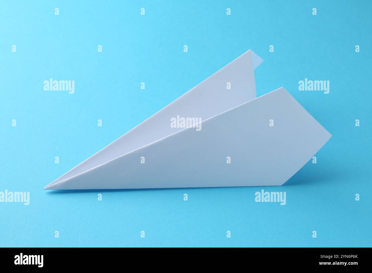 One handmade paper plane on light blue background Stock Photo - Alamy