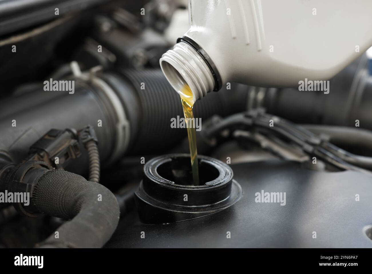 Pouring motor oil into car engine, closeup Stock Photo - Alamy