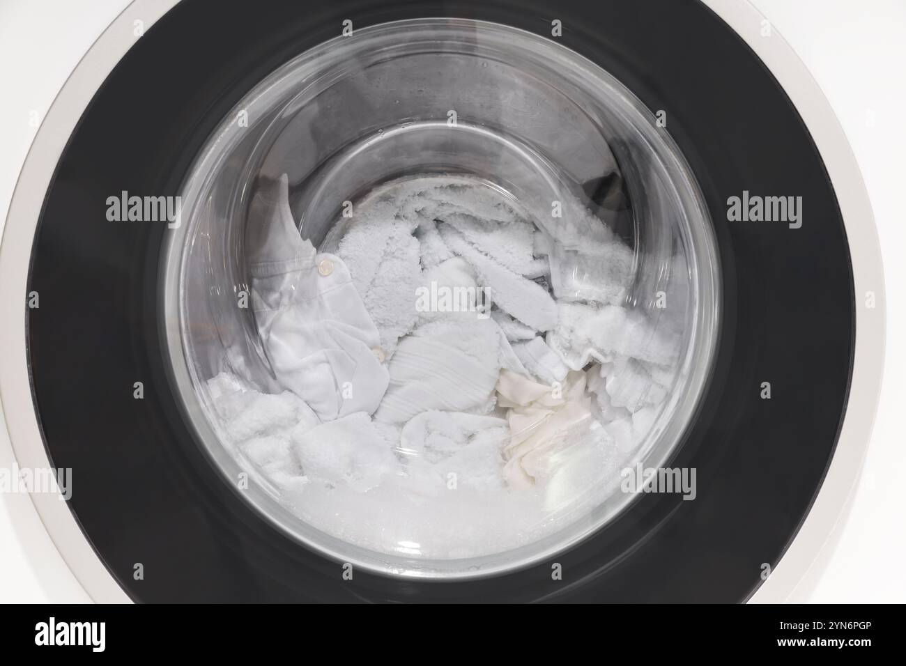 Washing machine with clothes as background, closeup Stock Photo - Alamy