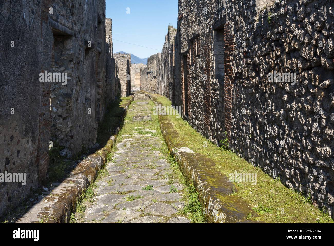 POMPEII, ITALY, MAY 04, 2022, A beautiful typical cobbled street in the ancient city of Pompeii ...
