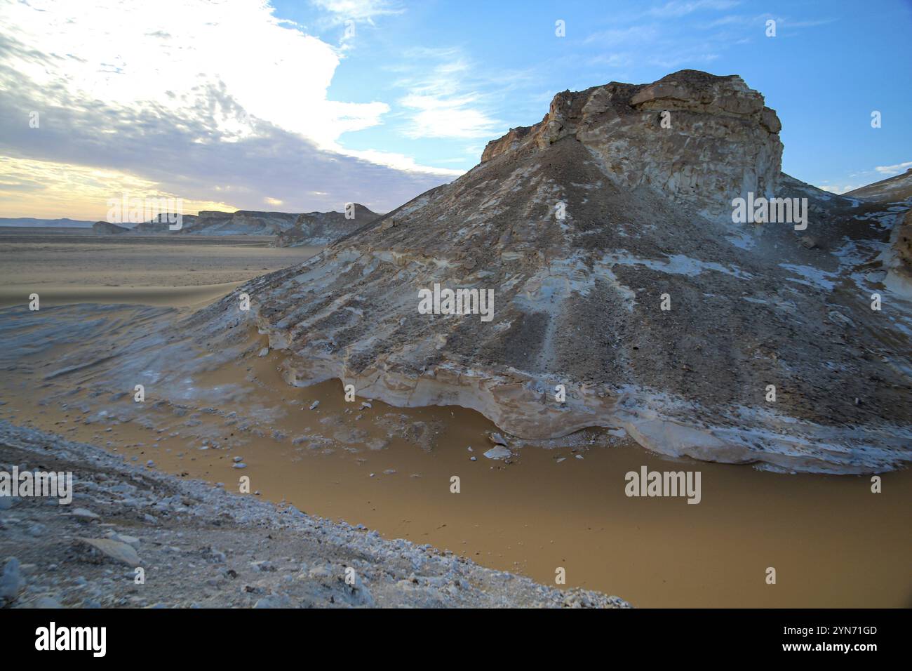 Late afternoon sun casting shadows on rocks in the Libyan desert white ...