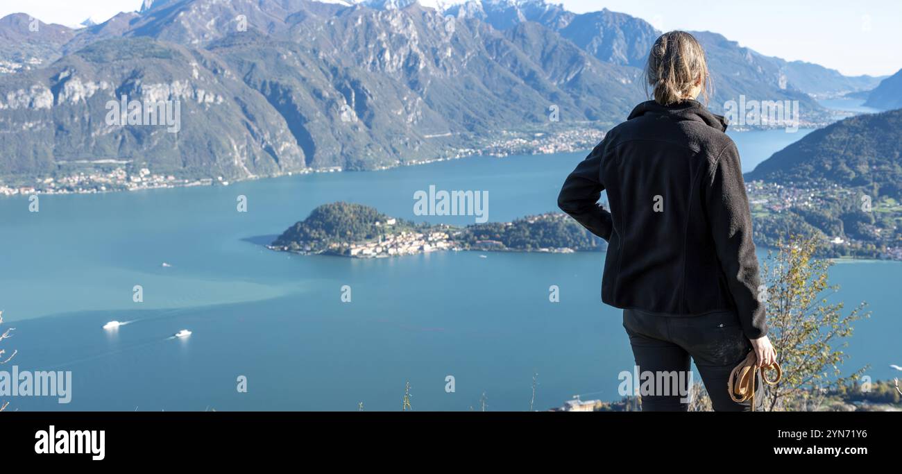A hiker enjoying the magnificent view of Bellagio at lake Como seen ...