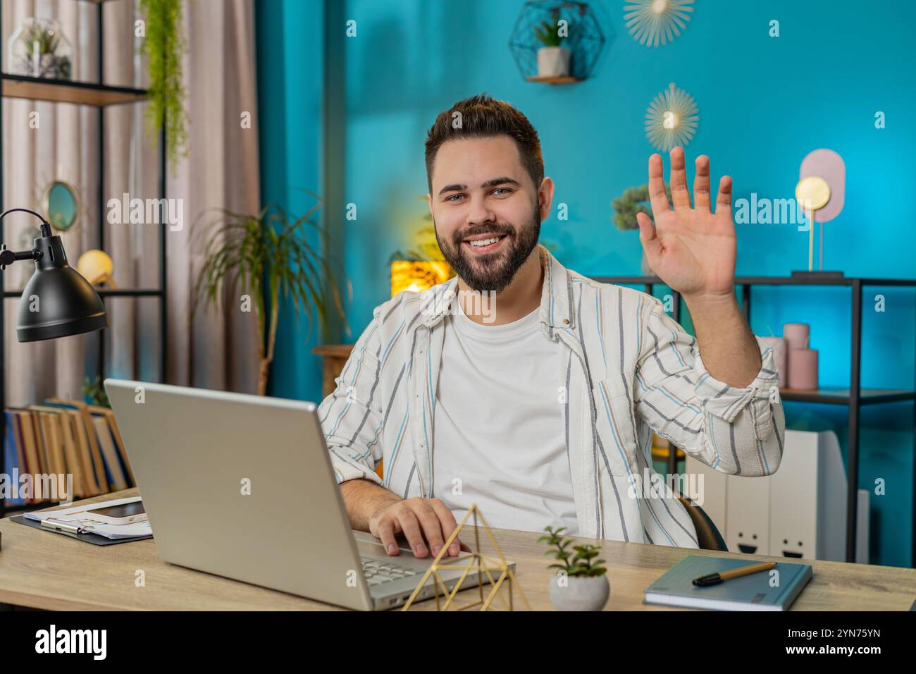 Hello. Caucasian young freelancer man smiling friendly at camera and ...