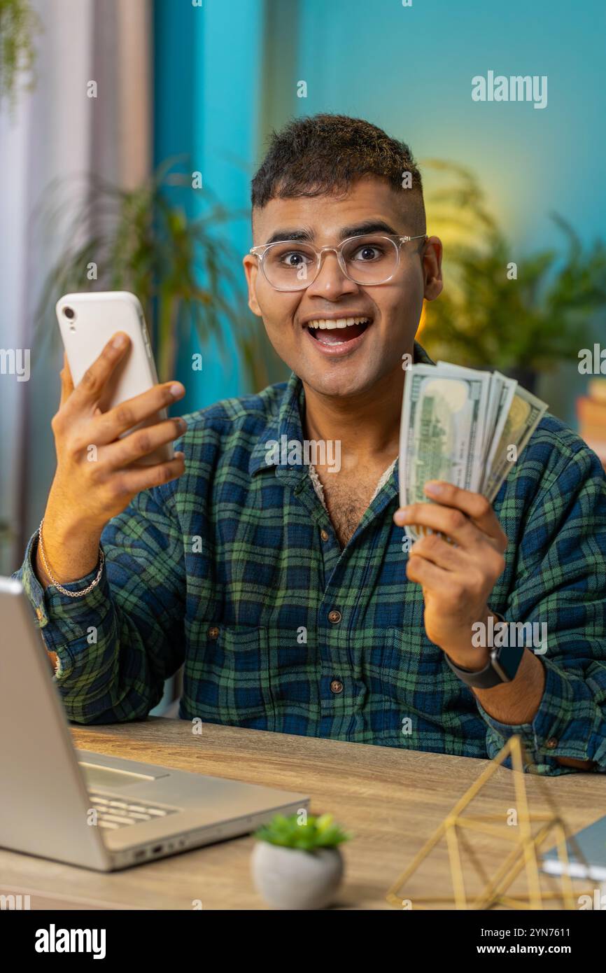 Planning family budget. Happy Indian man counting money cash use ...