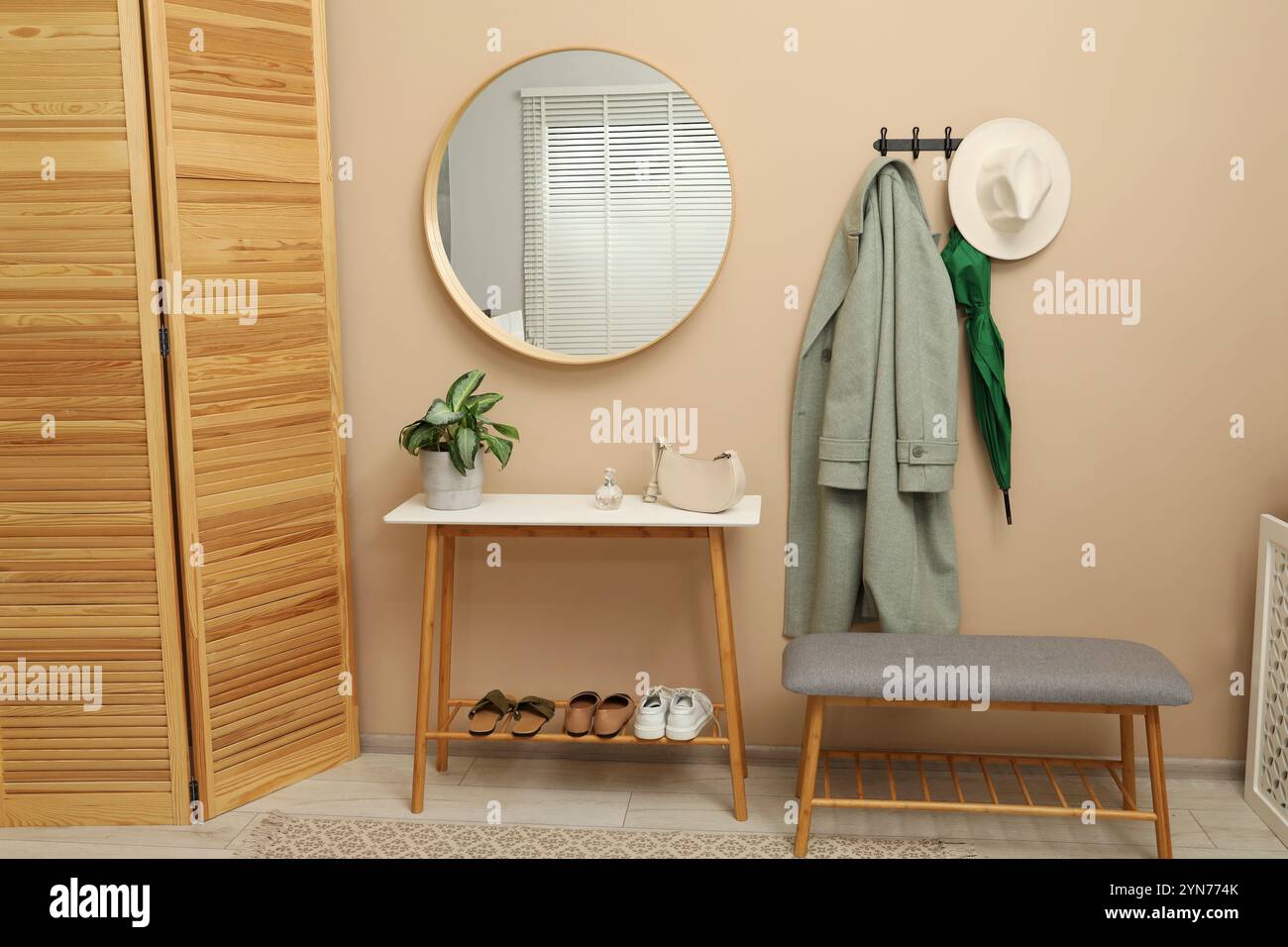 Coat rack with clothes, mirror, shoe storage benches and folding screen ...