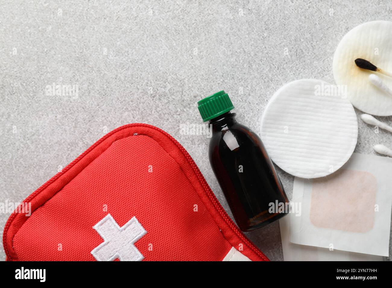 Topical iodine and other first aid kit components on light background ...