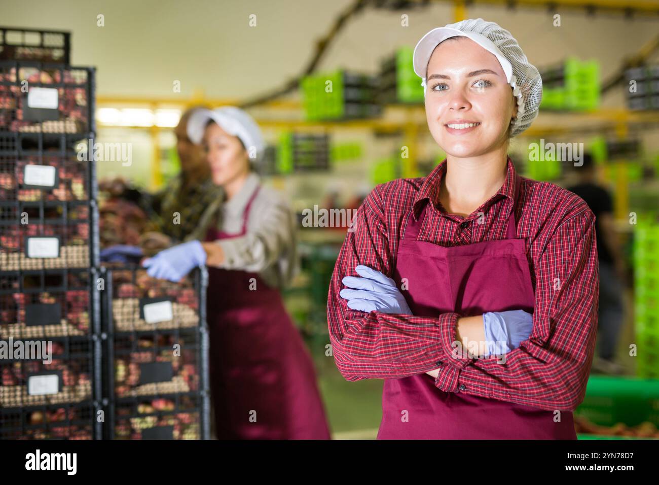 Women warehouse workers near crate Stock Photo - Alamy