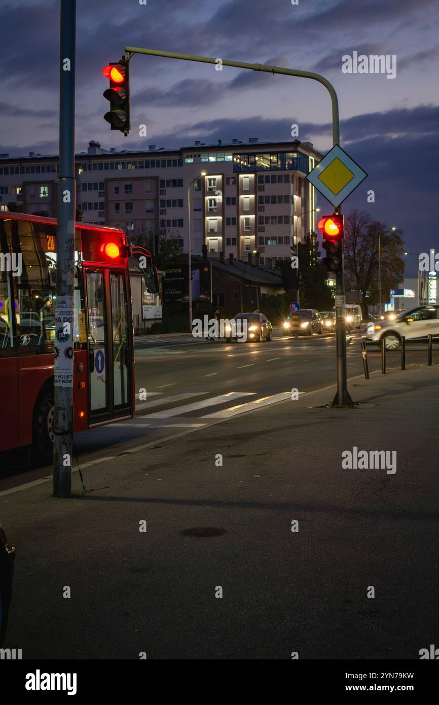 Red bus waiting on red light Stock Photo - Alamy
