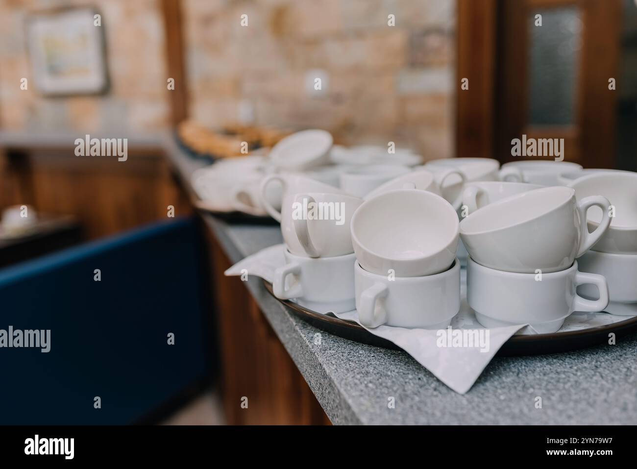 several cups neatly arranged on a sleek bar counter, their simple ...