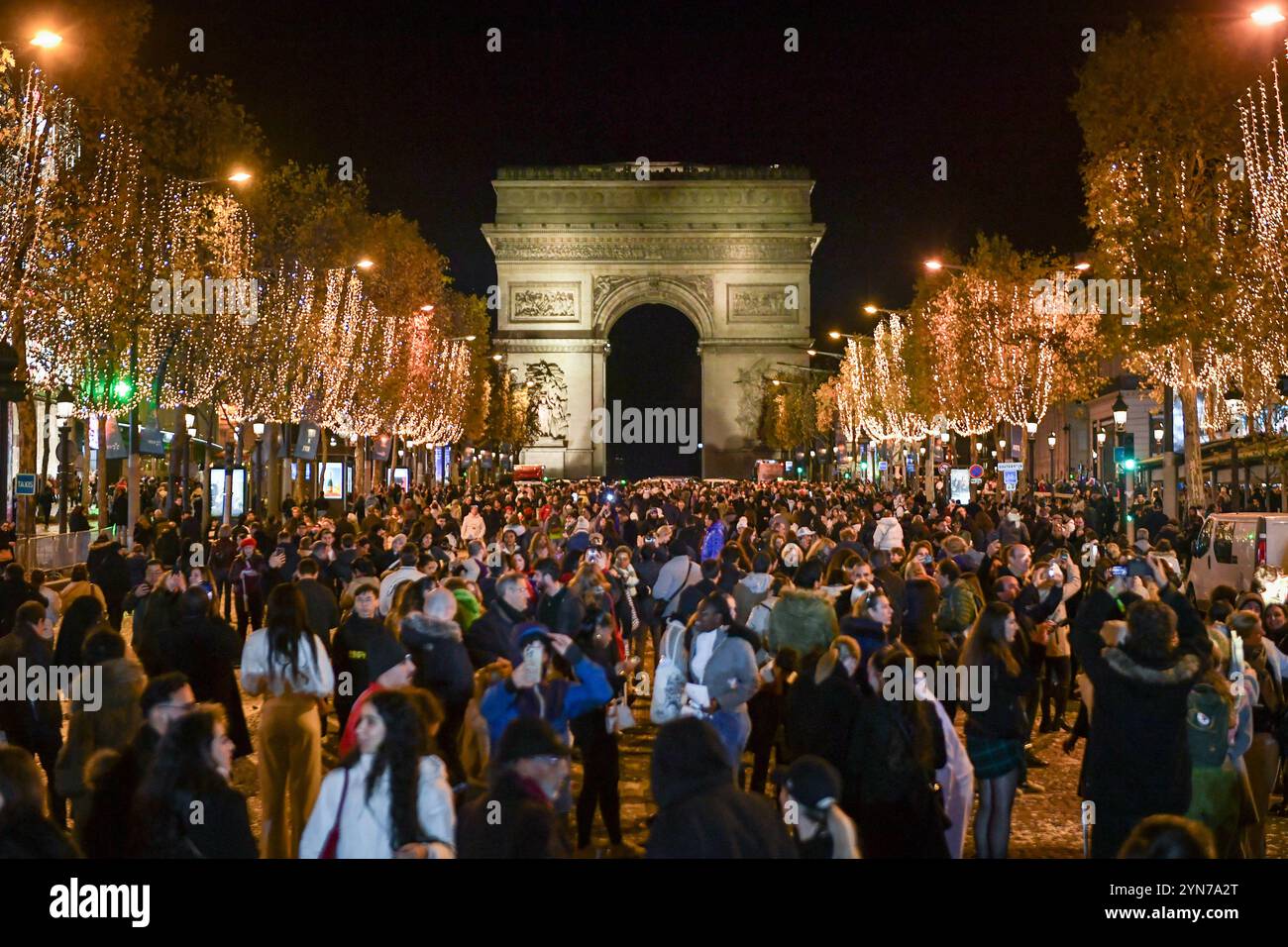 Christmas enthusiasts attend the Champs Elysees Christmas Lights ...