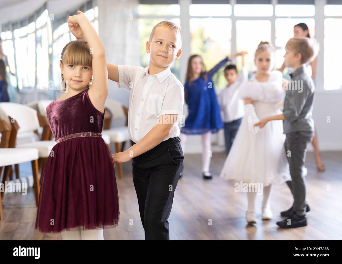 Tween girls ad boys dancing slow partner dance during festive event ...