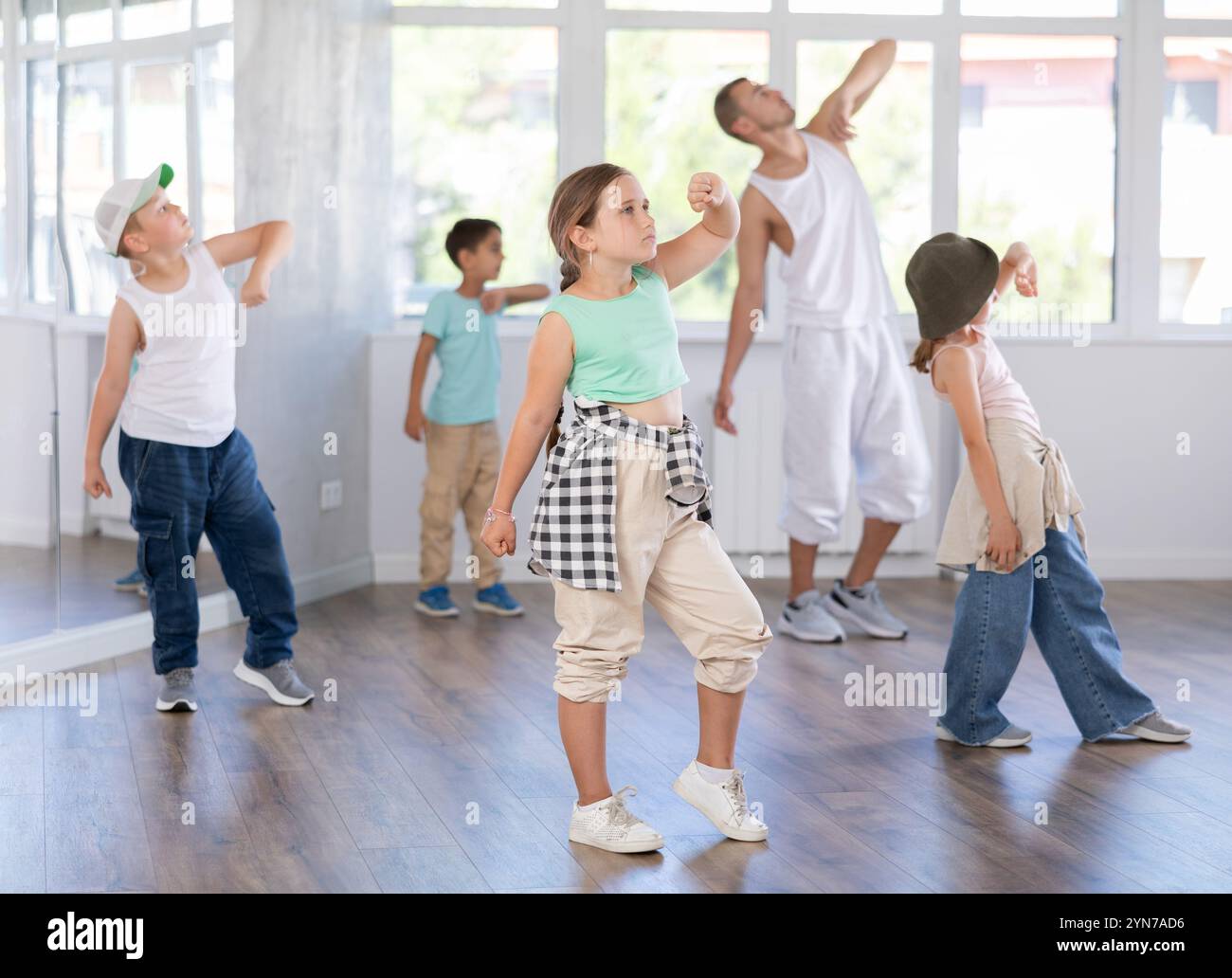 Tween girl dancer rehearsing krump dance at group workout Stock Photo ...