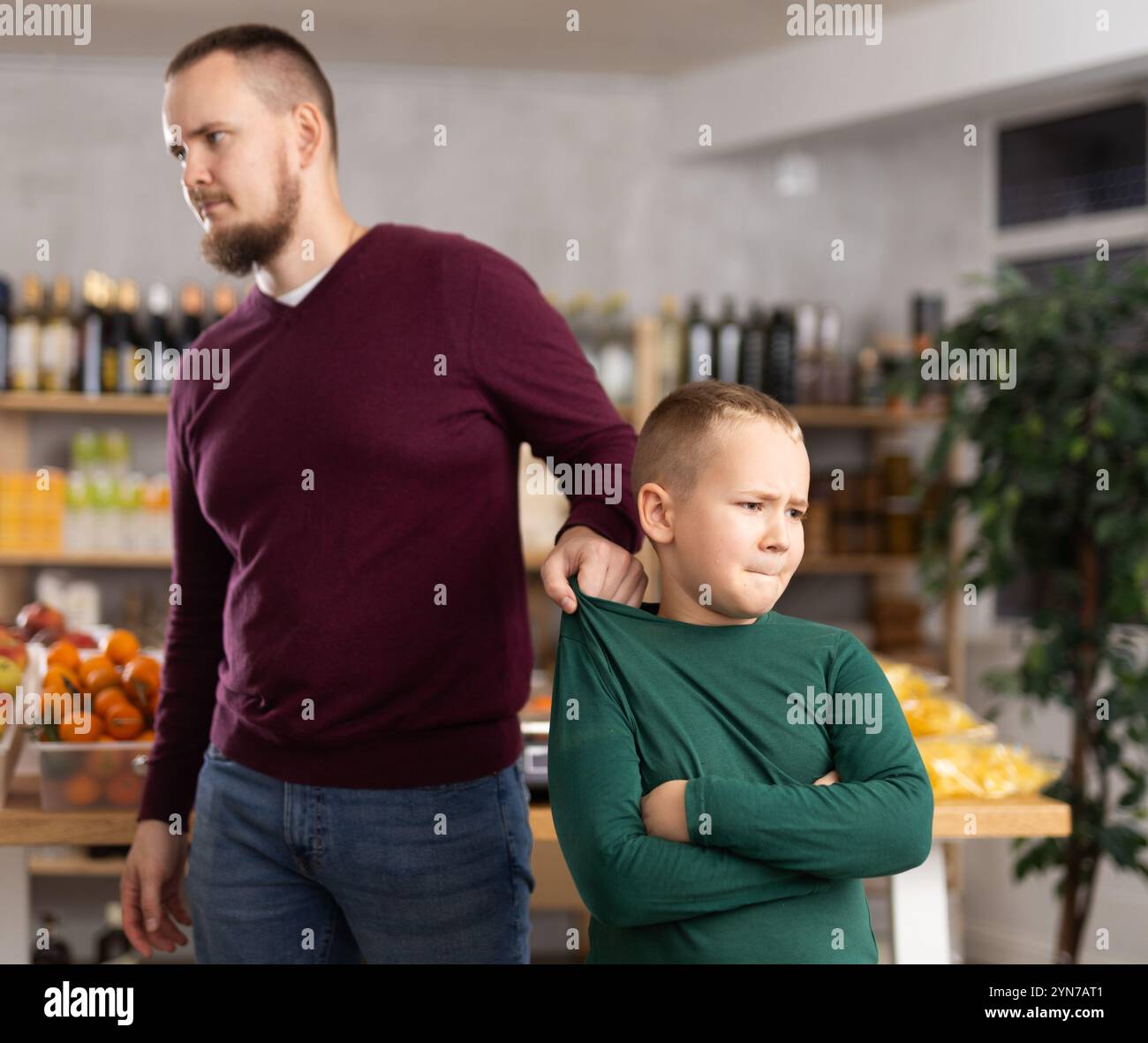 Angry dad dragging his little son behaving capricious in market Stock ...