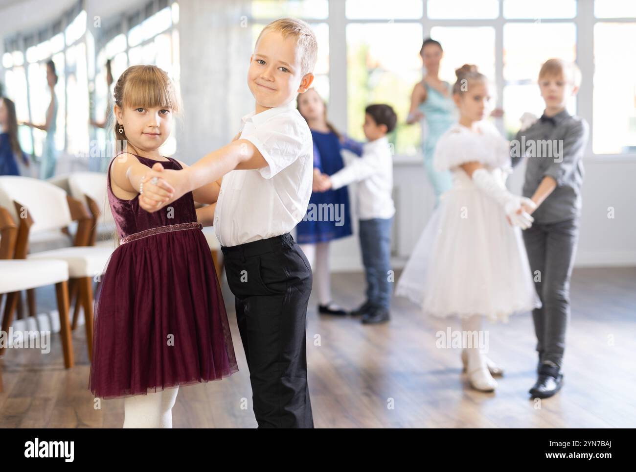 Tween girls ad boys dancing slow partner dance during festive event ...