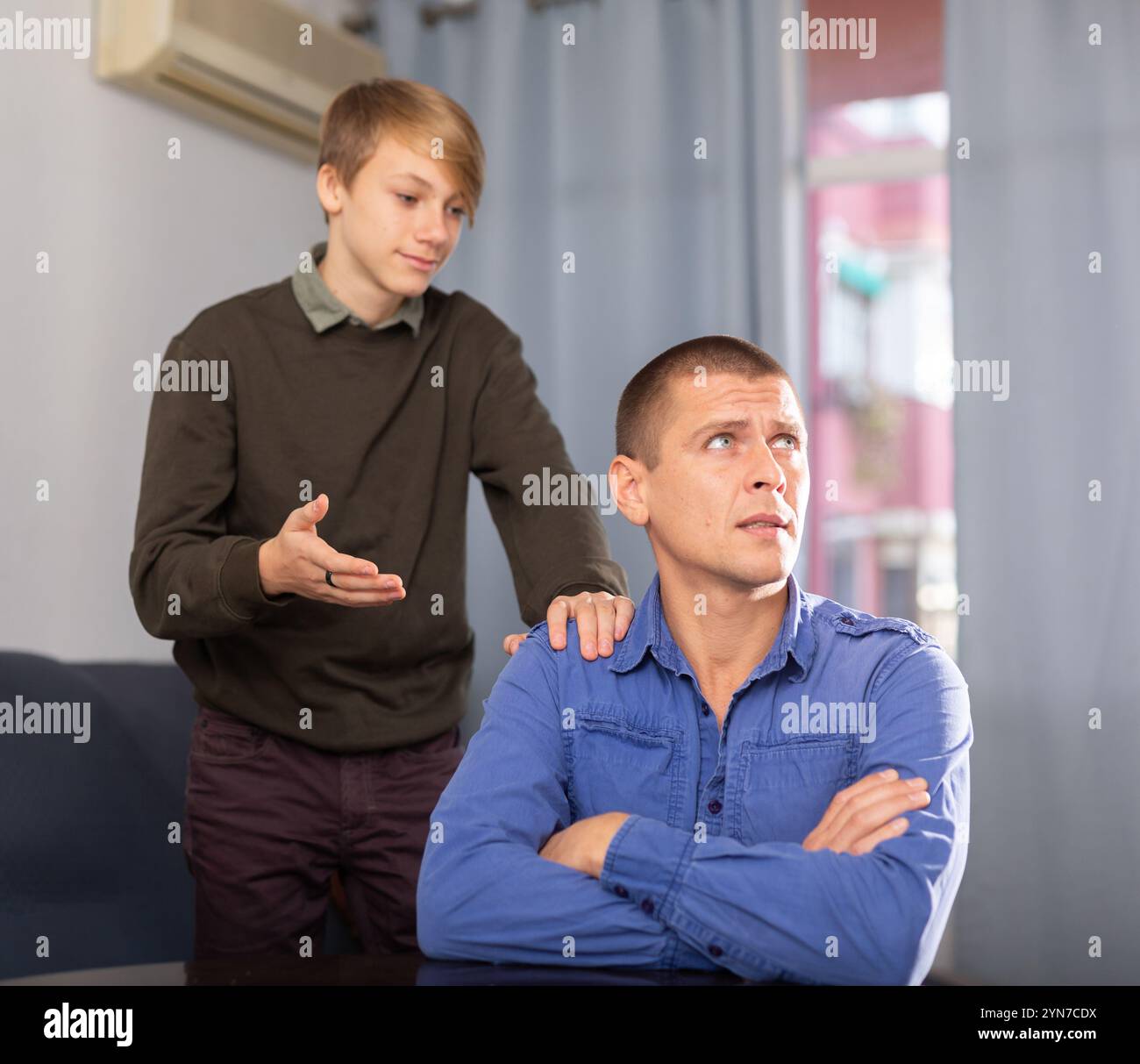 Adult man ignoring his son Stock Photo - Alamy