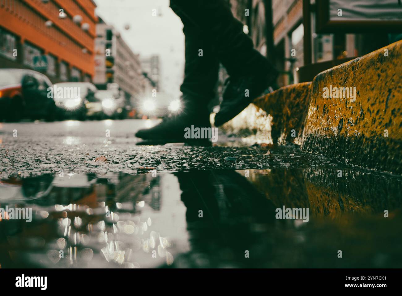 Reflection man on street puddle hi-res stock photography and images - Alamy