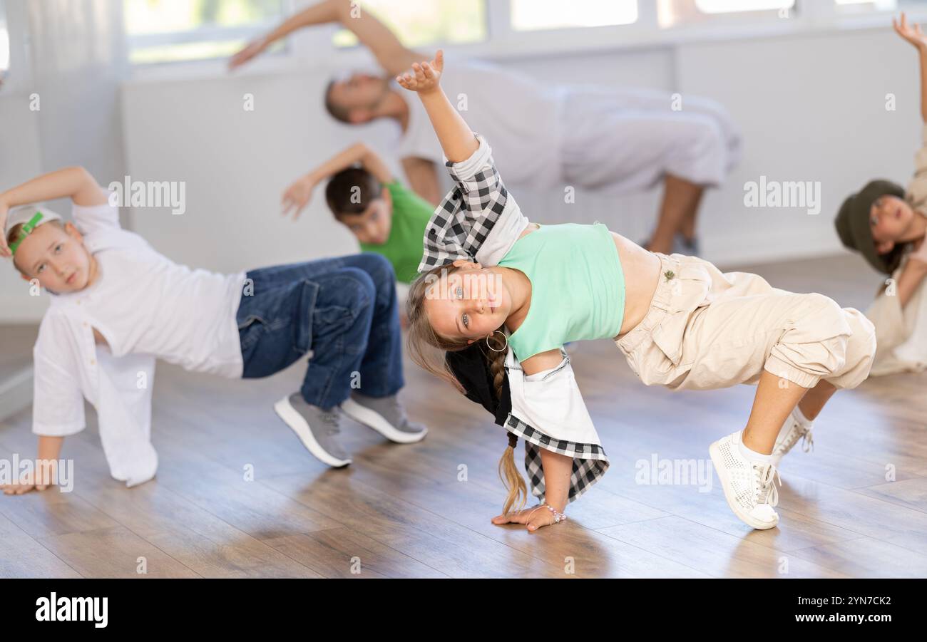 Tween girl dancer rehearsing krump dance at group workout Stock Photo ...