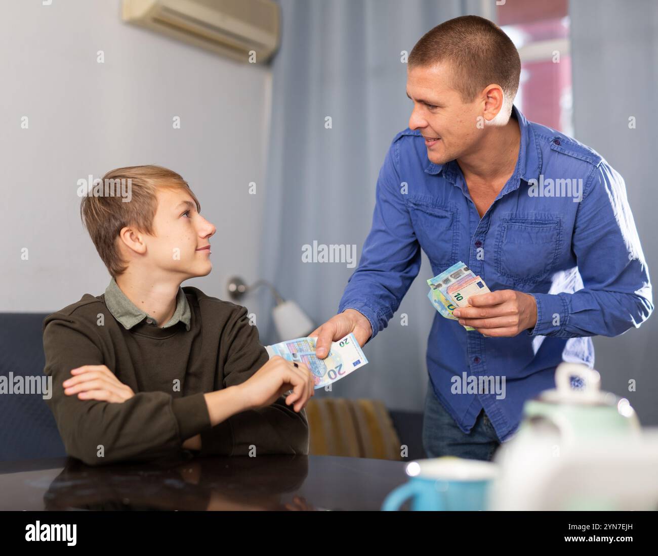 Father giving his teenage son pocket money Stock Photo - Alamy