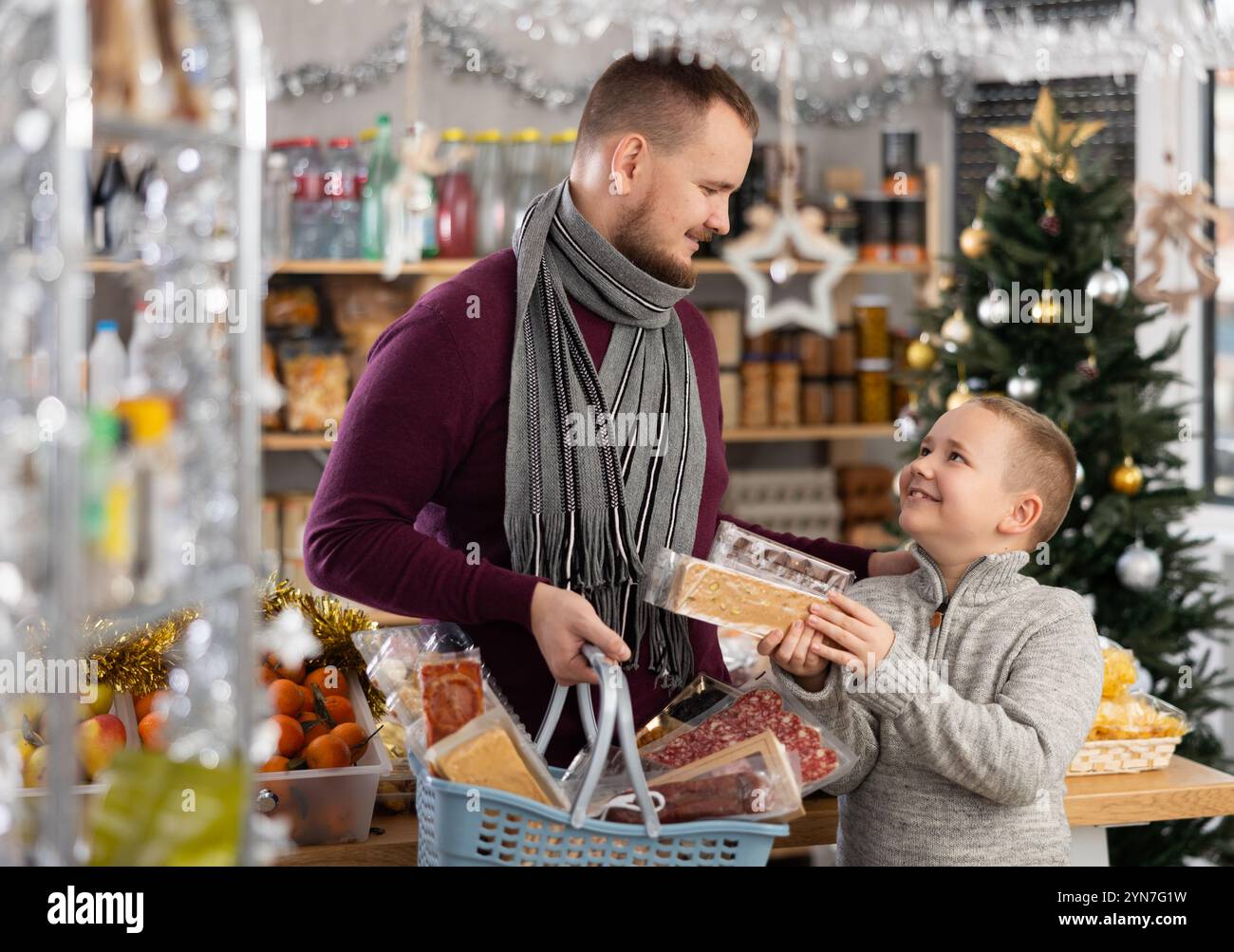 Young man with son choosing sweets at grocery store Stock Photo - Alamy