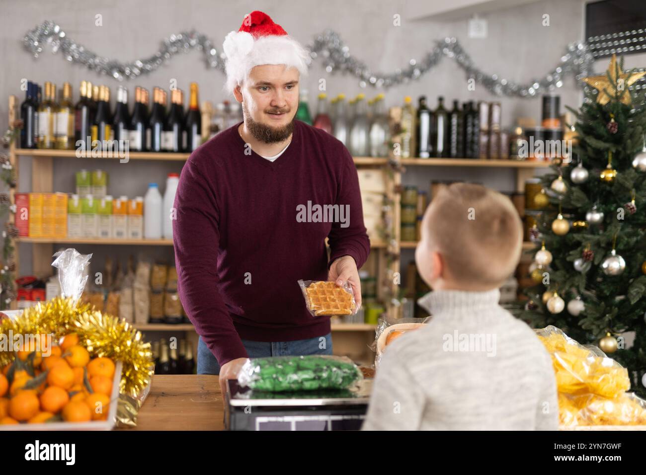 Salesman weighs candies in a supermarket Stock Photo - Alamy